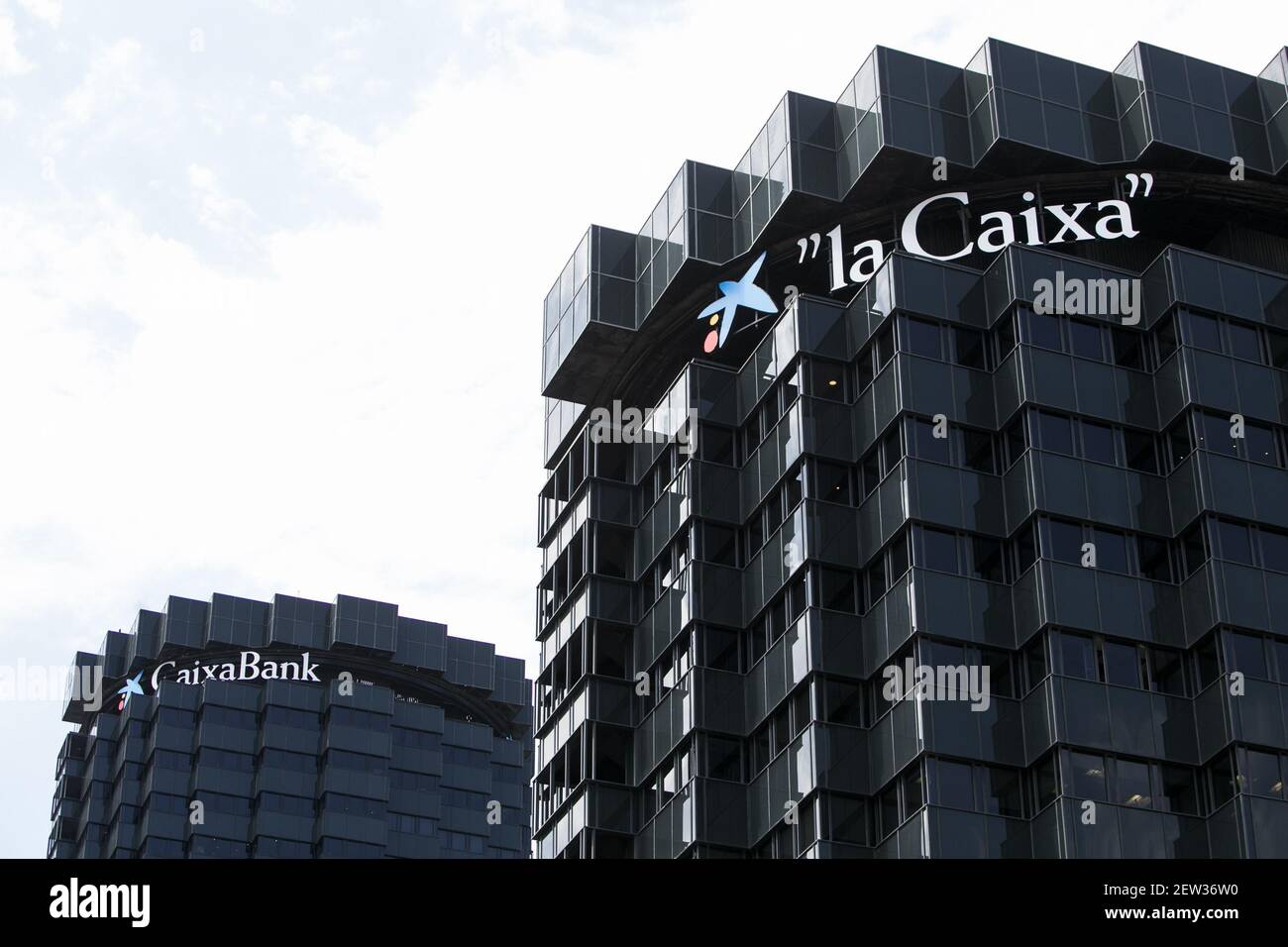 A logo sign outside of the headquarters of the La Caixa group and Caixa ...