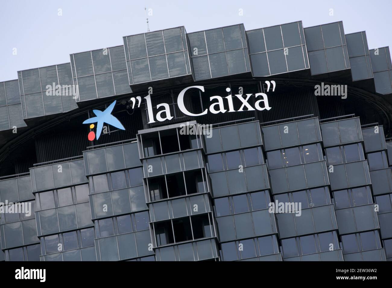 A logo sign outside of the headquarters of the La Caixa group and Caixa ...