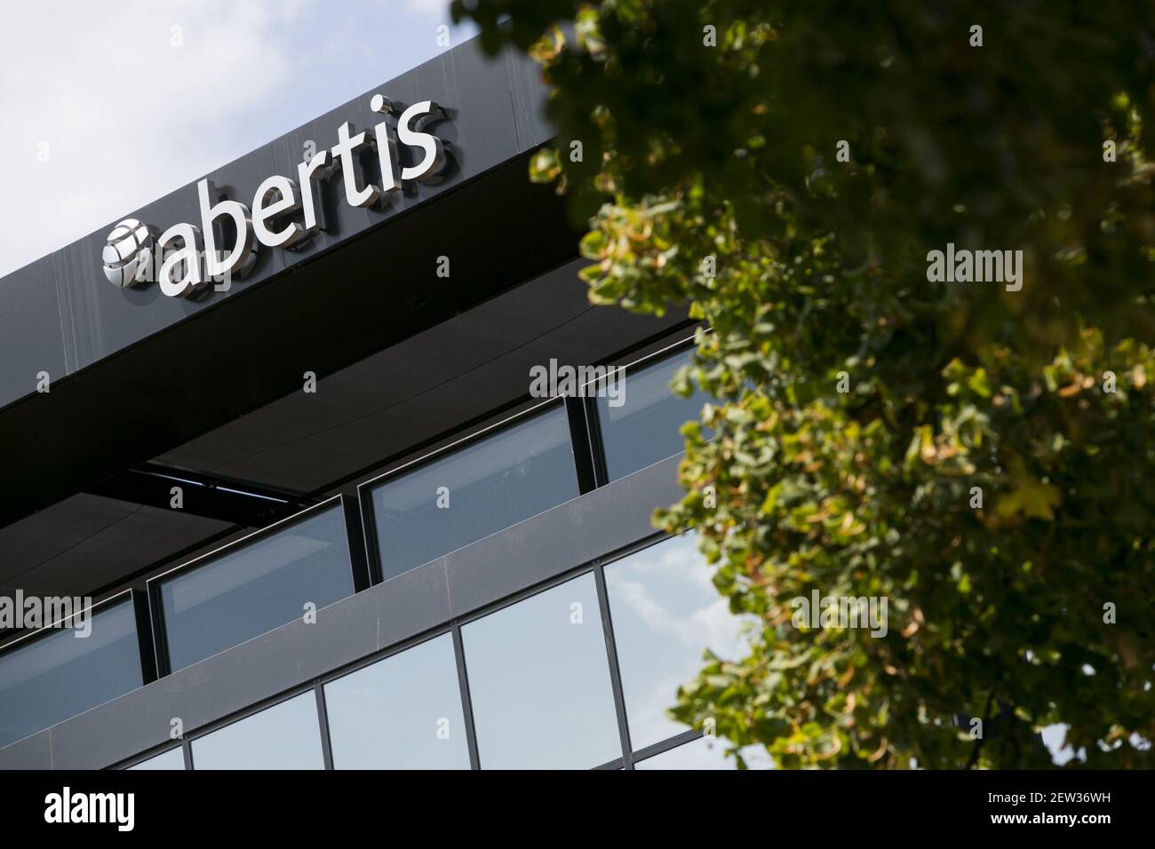 A logo sign outside of the headquarters of Abertis Infraestructuras in ...