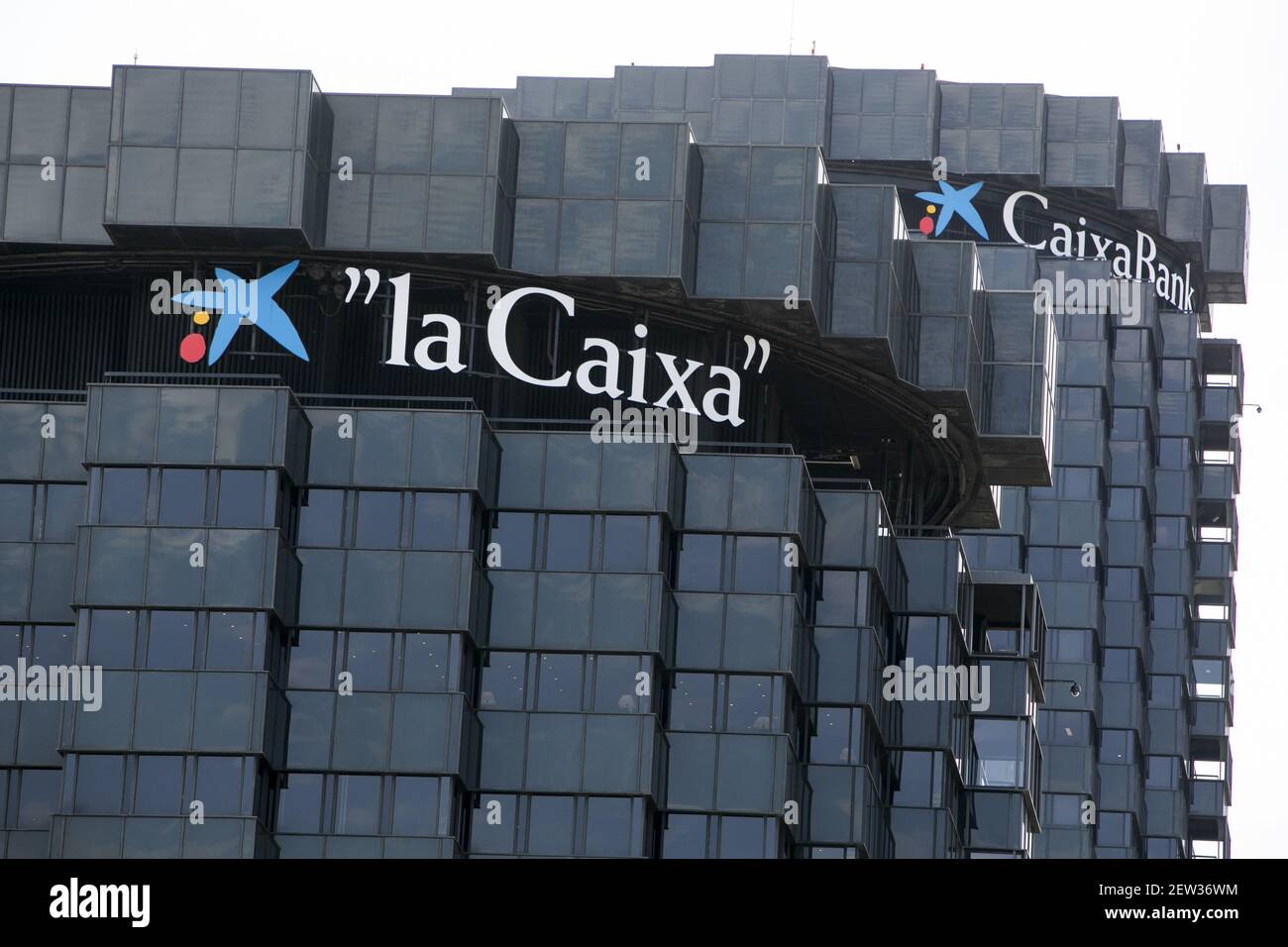 A logo sign outside of the headquarters of the La Caixa group and Caixa ...