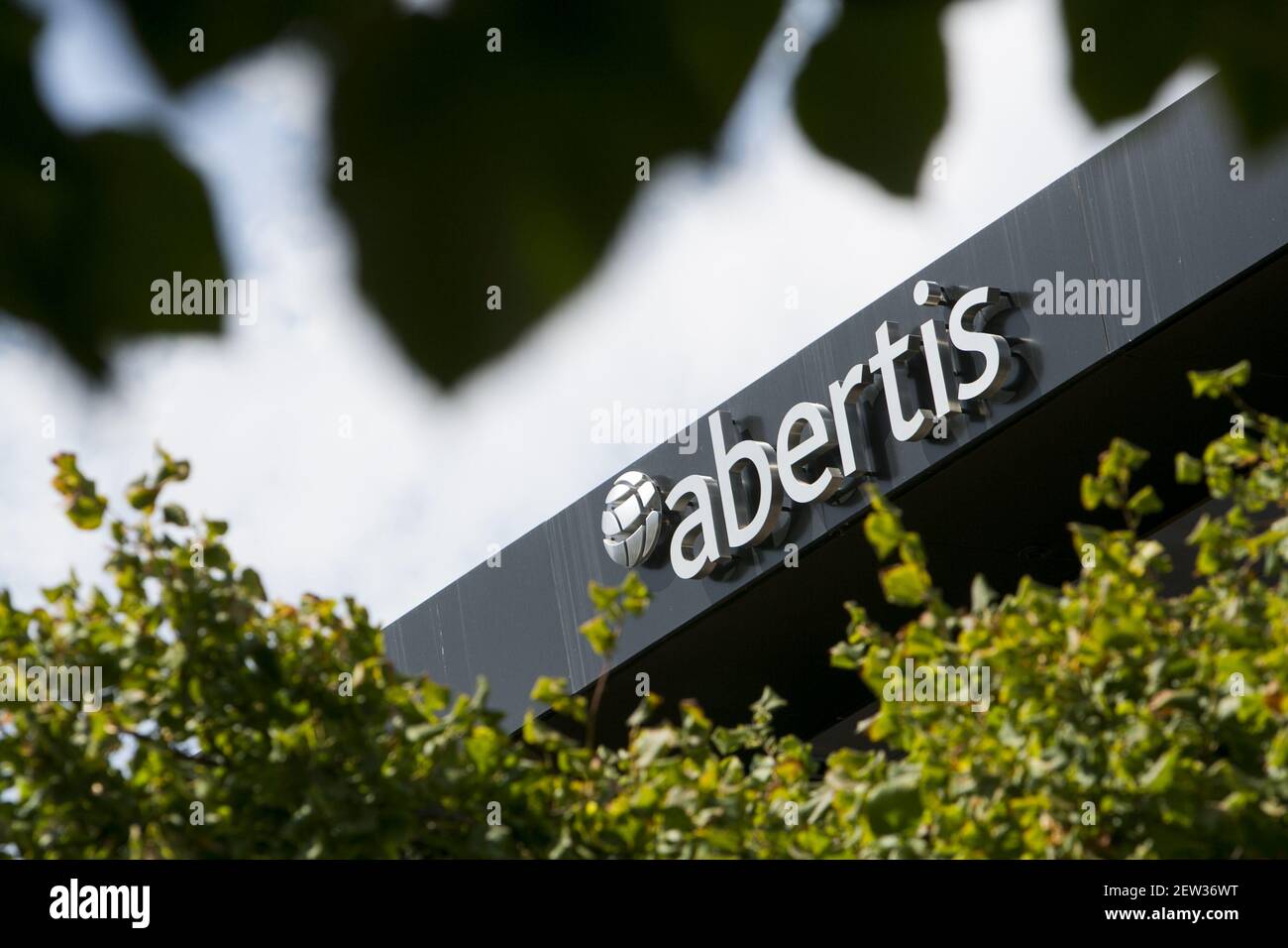 A logo sign outside of the headquarters of Abertis Infraestructuras in ...
