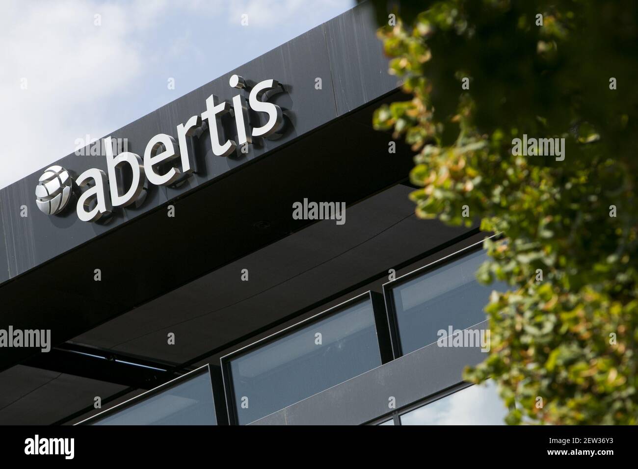 A logo sign outside of the headquarters of Abertis Infraestructuras in ...