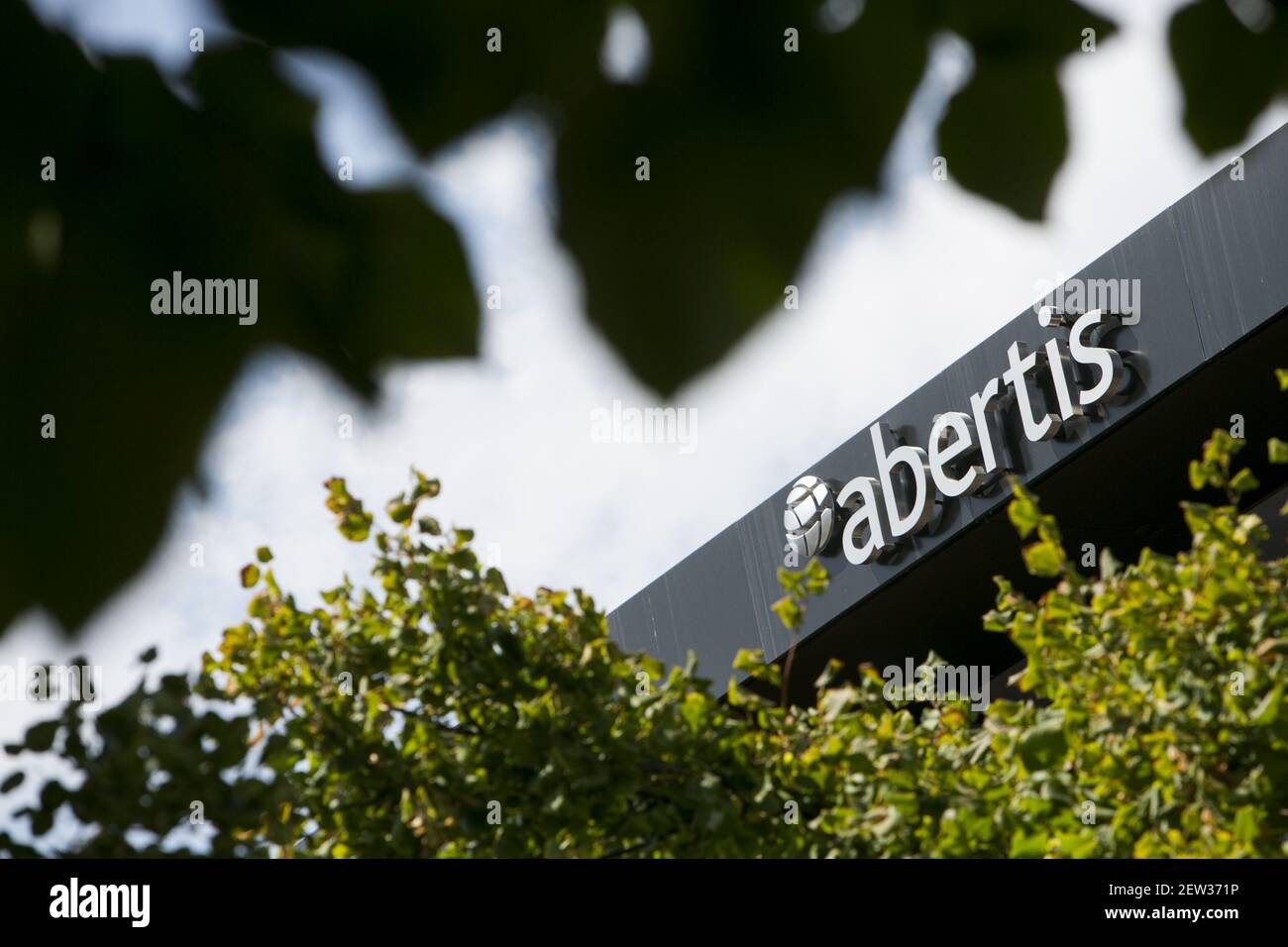 A logo sign outside of the headquarters of Abertis Infraestructuras in ...