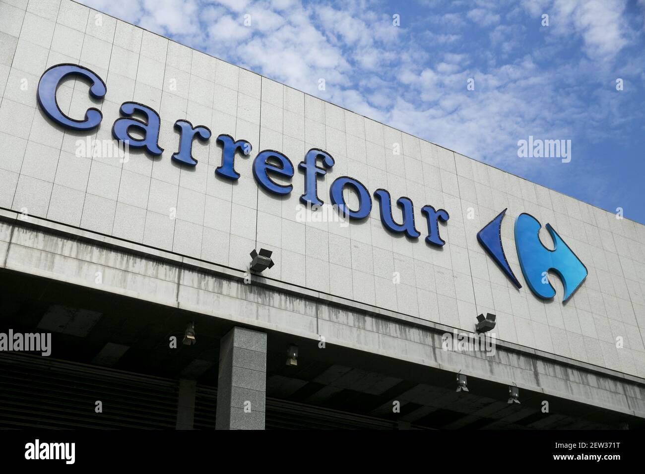 A logo sign outside of a Carrefour retail store in Barcelona, Spain on ...
