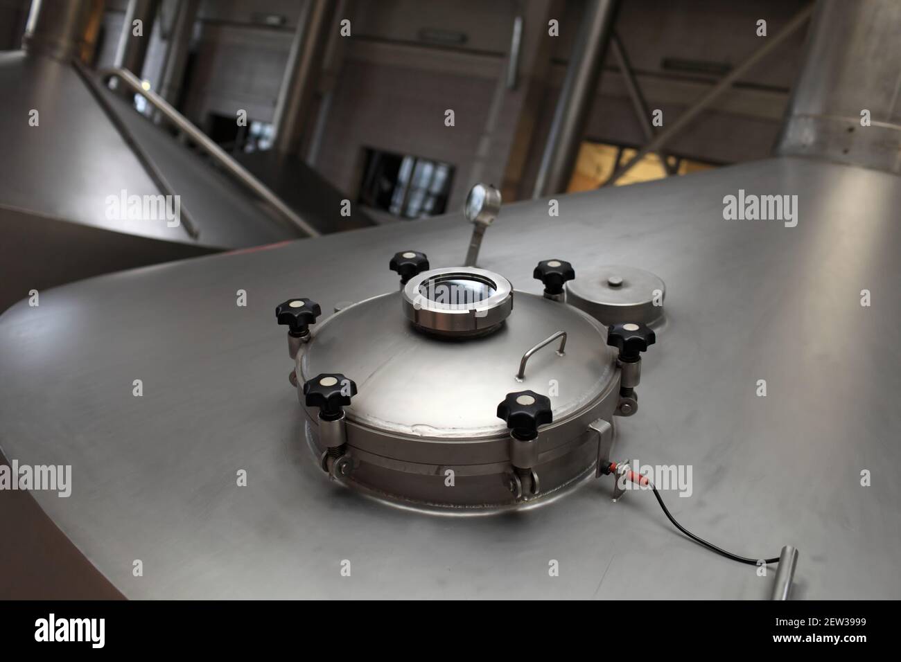 View manhole of fermentation vat in the modern brewery Stock Photo - Alamy