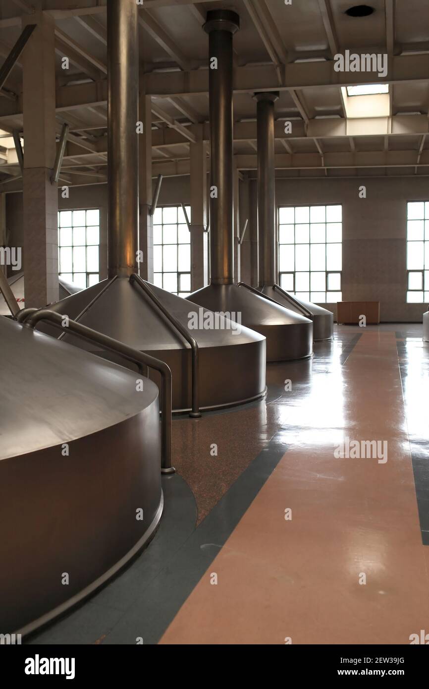 Interior of a modern brewery. Details of the stainless steel tanks ...