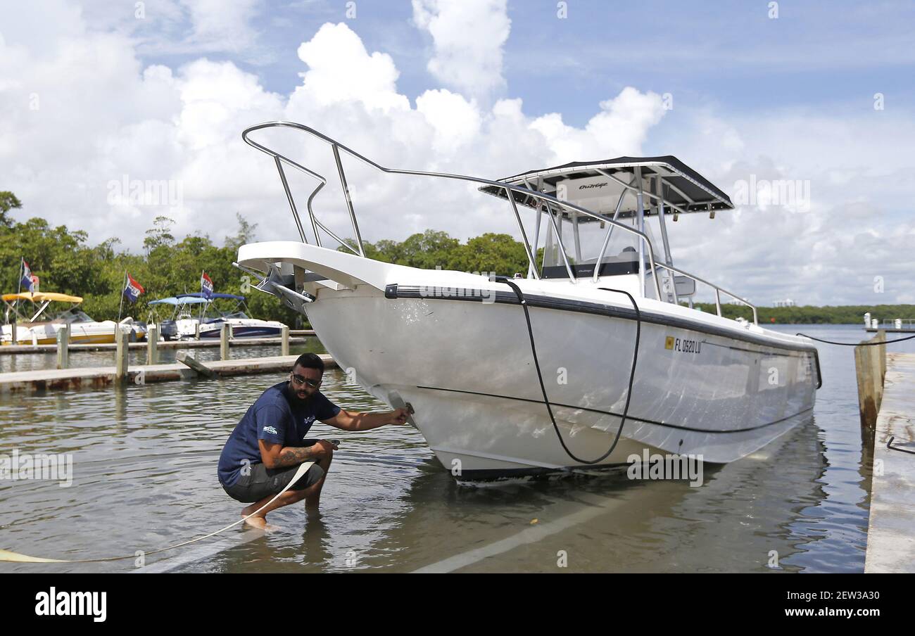 Haulover Marine Center employee Rayden Marquez pulls out one of the ...