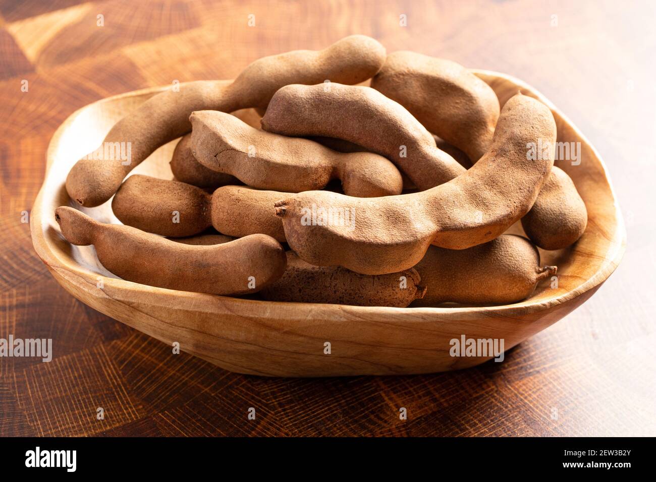 Tamarind Beans in Shell on a Brown Butchers Block Stock Photo - Alamy