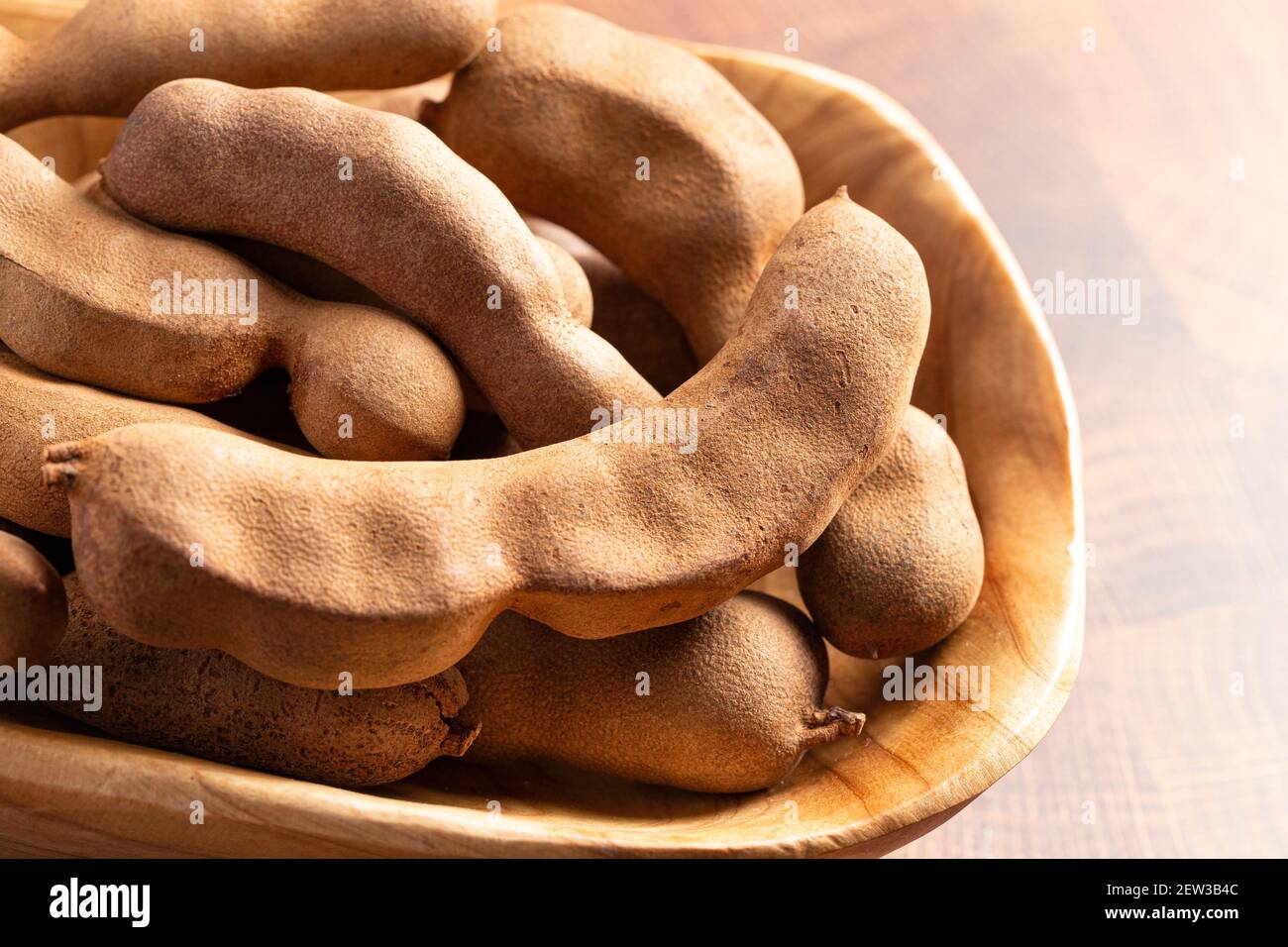 Tamarind Beans in Shell on a Brown Butchers Block Stock Photo - Alamy