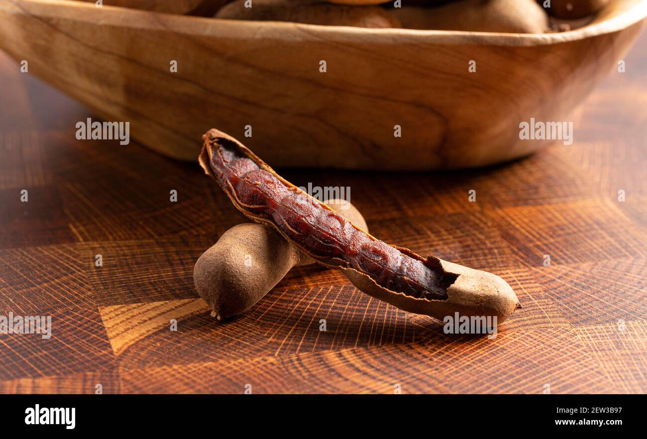 Tamarind Beans in Shell on a Brown Butchers Block Stock Photo - Alamy