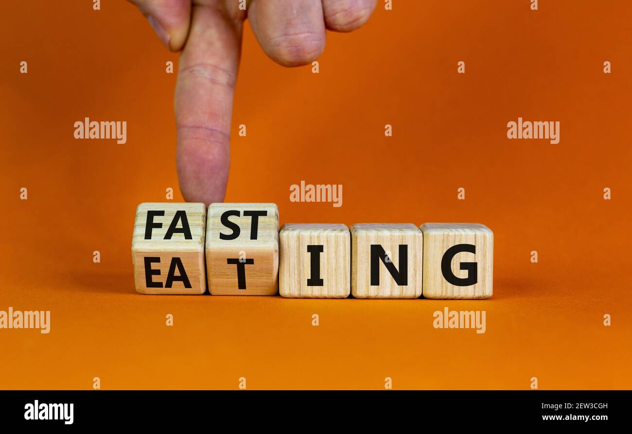 Fasting or eating symbol. Doctor turns wooden cubes and changes the ...