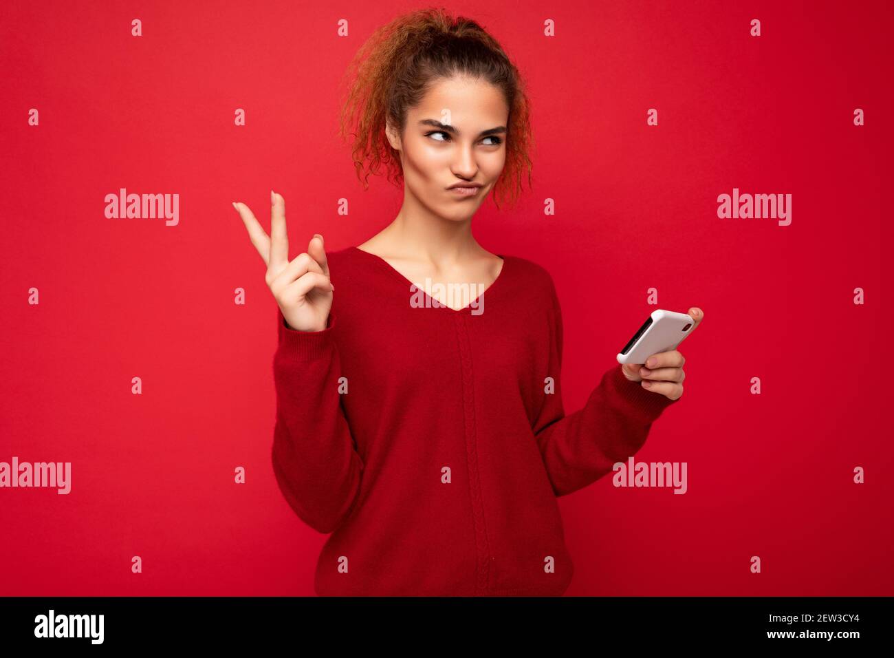 Photo of happy smiling woman with gathered curly hair wearing dark red ...