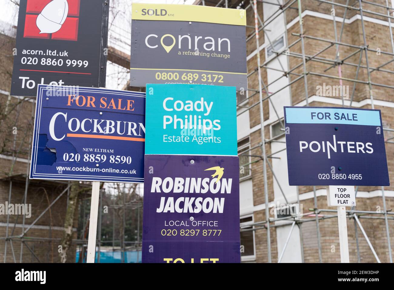 Estate agent sale signs outside council flats Stock Photo - Alamy