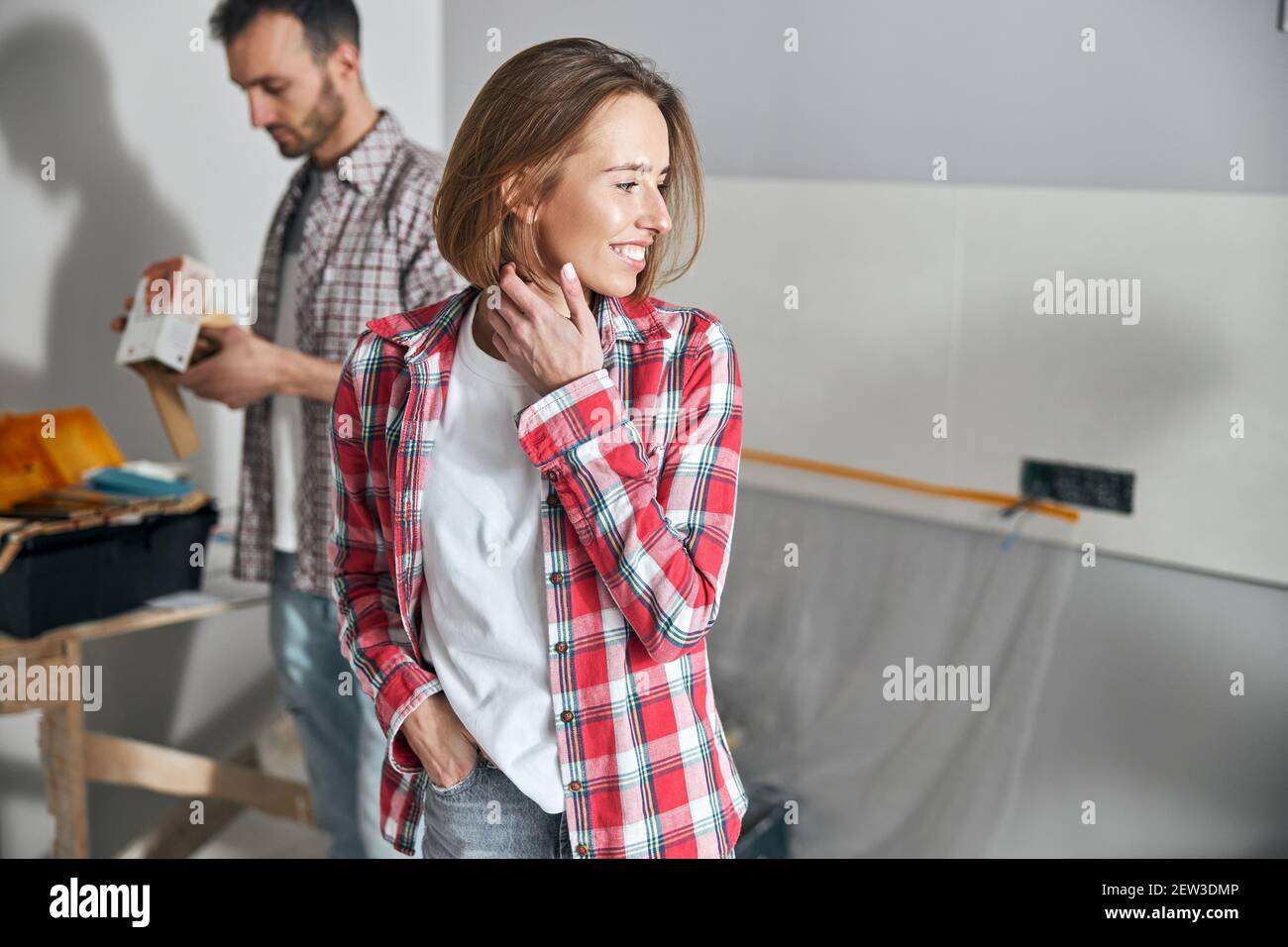 Focused workman standing at a wooden table with a toolbox Stock Photo ...