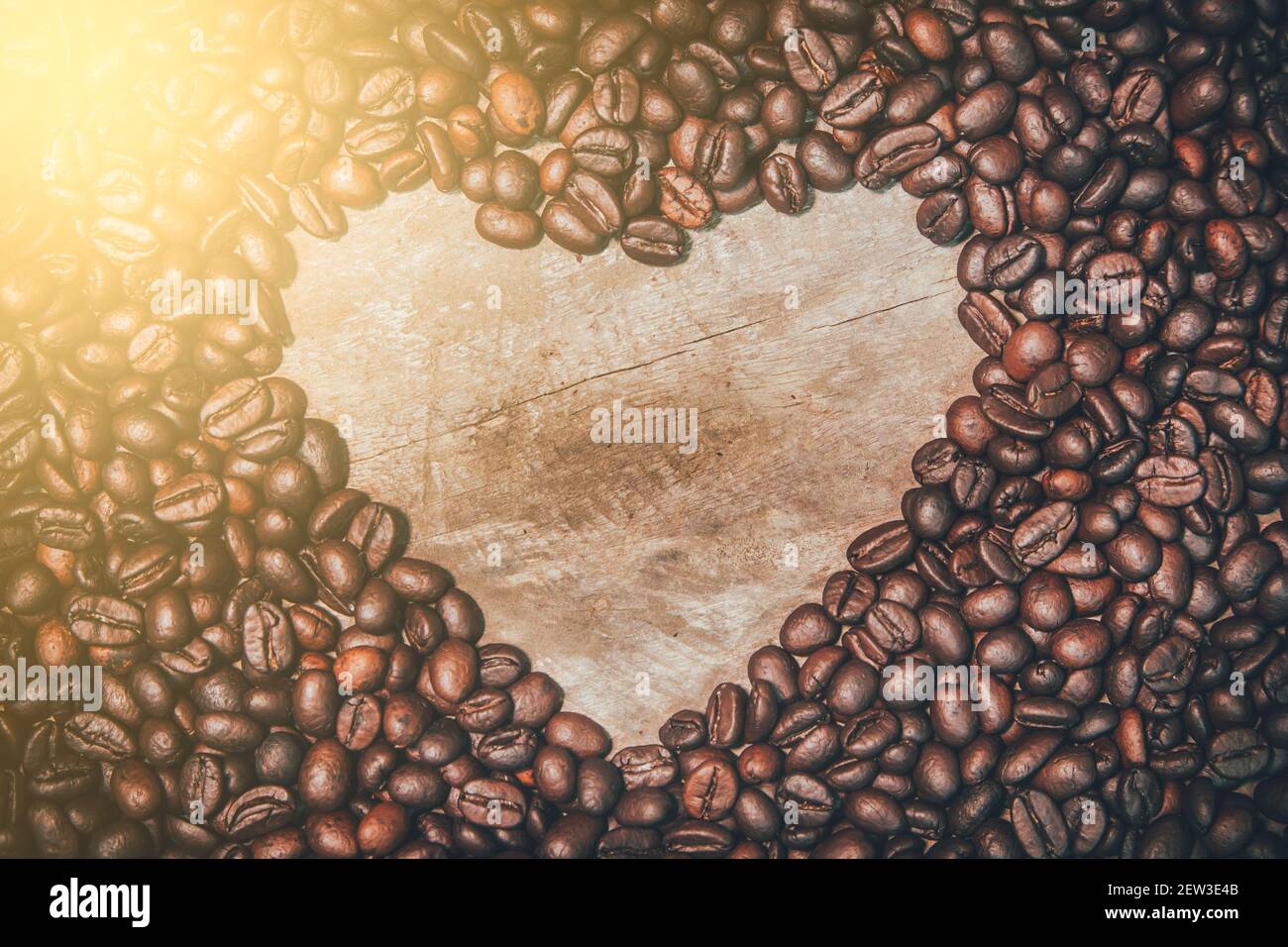 Coffee beans placed on old wooden boards with free space for ...