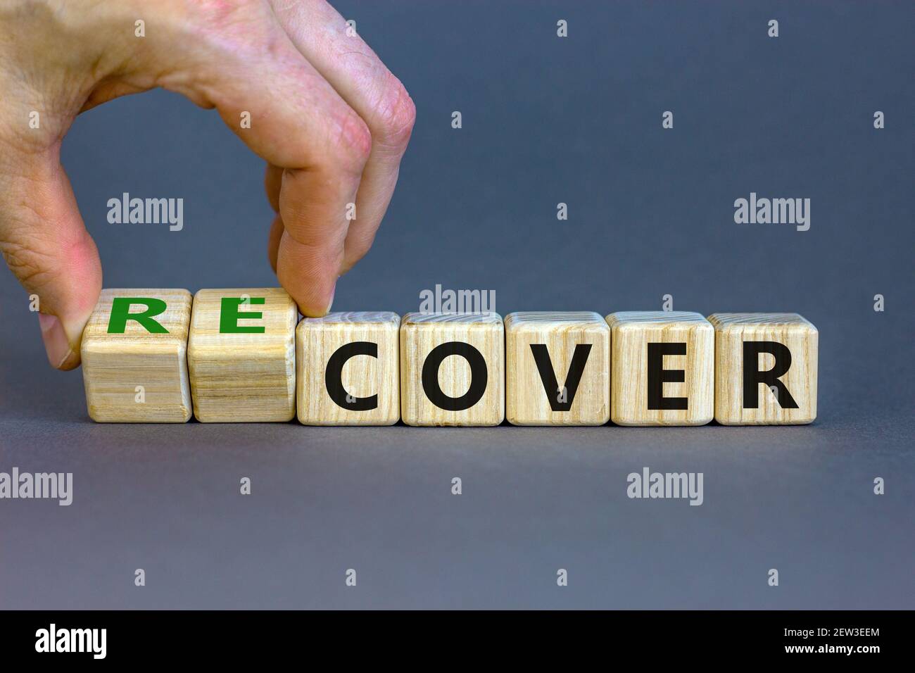 Time to recover symbol. Businessman turns wooden cubes and changes the ...