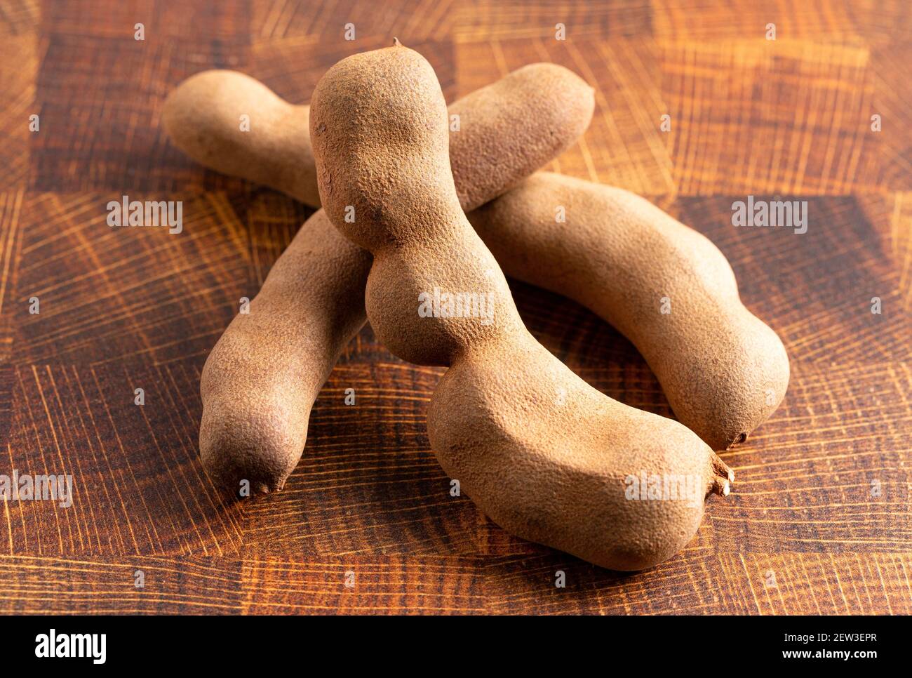 Tamarind Beans in Shell on a Brown Butchers Block Stock Photo - Alamy