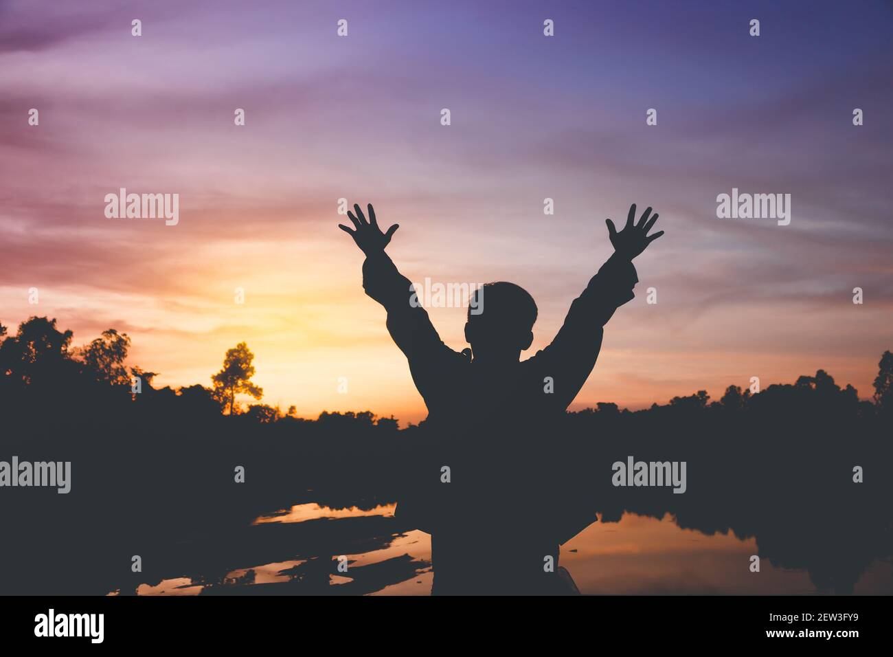 Silhouette man hands raised hi-res stock photography and images - Alamy