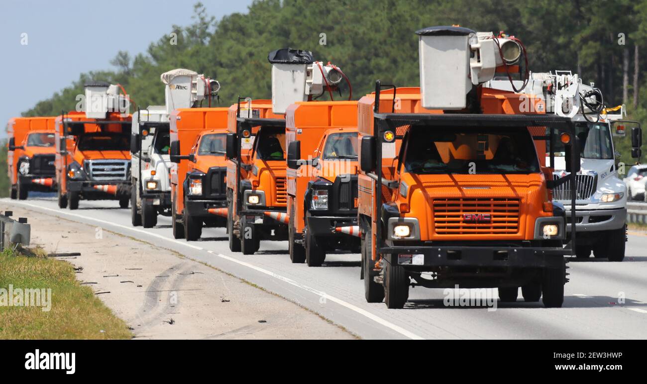 A line of power trucks head south on I-75 toward the Georgia coast in ...