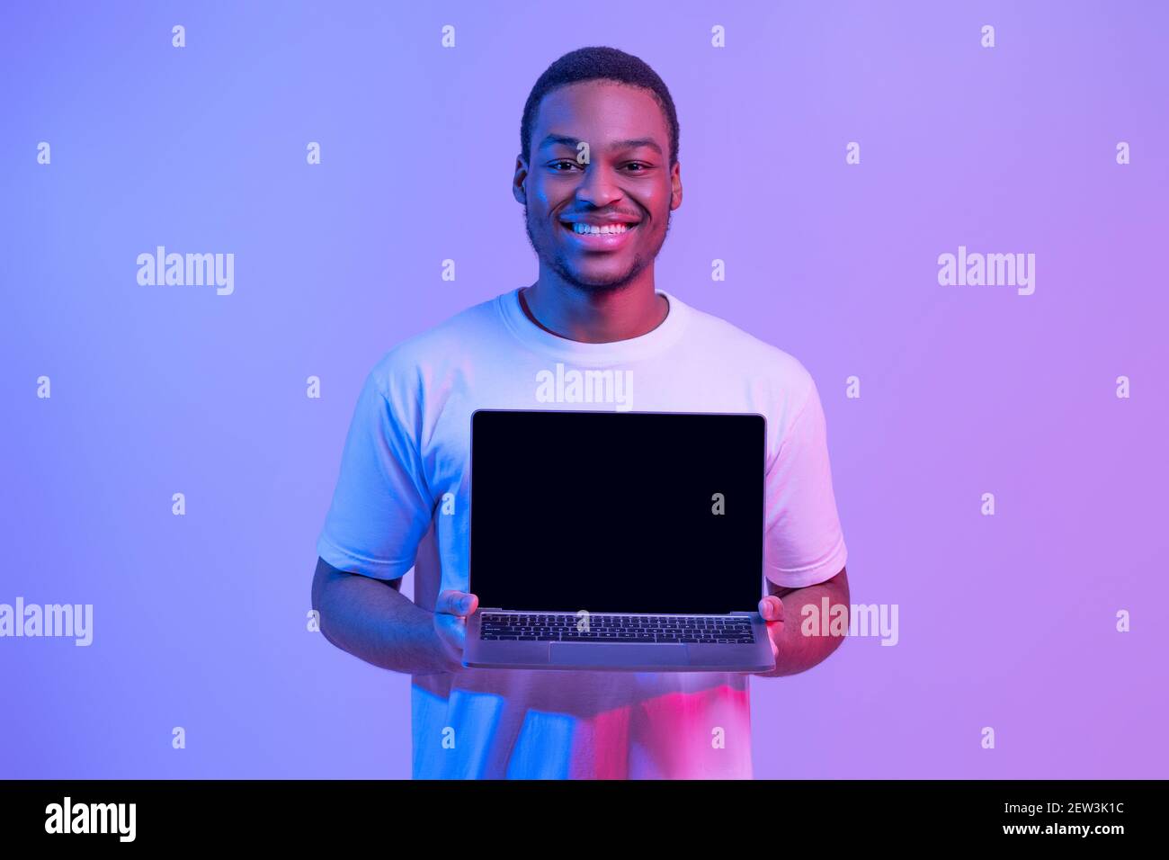 Man holding laptop computer hi-res stock photography and images - Alamy