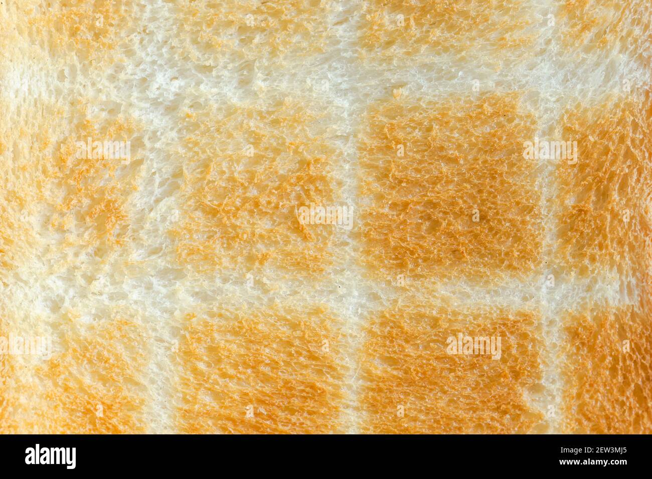 The texture and detail of the white toasted bread is golden yellow ...