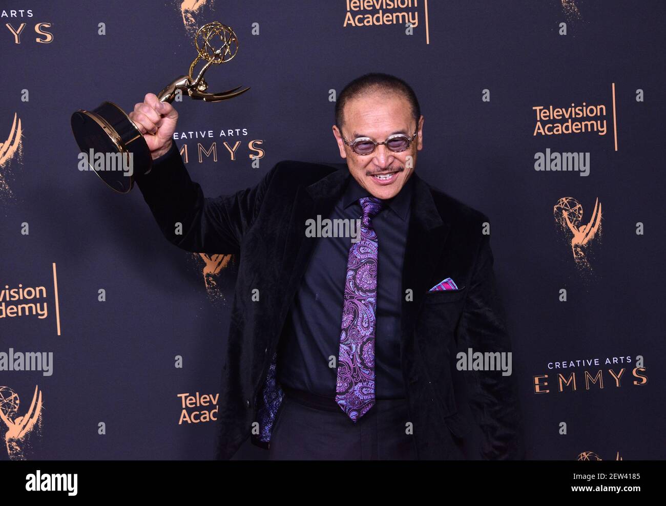 Stunt coordinator James Lew poses in the press room with the award for ...