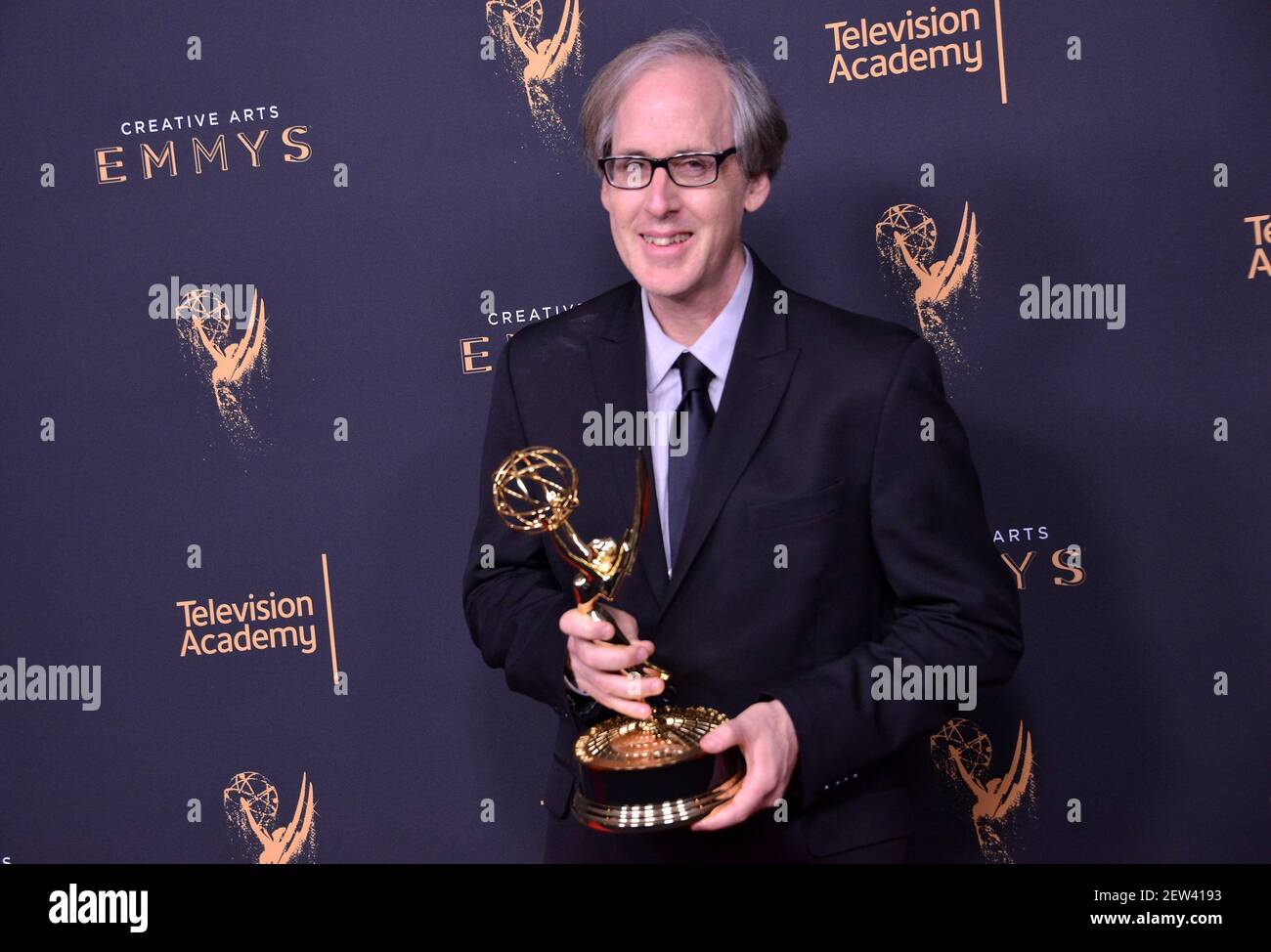 Jeff Beal poses in the press room with the award for outstanding music ...