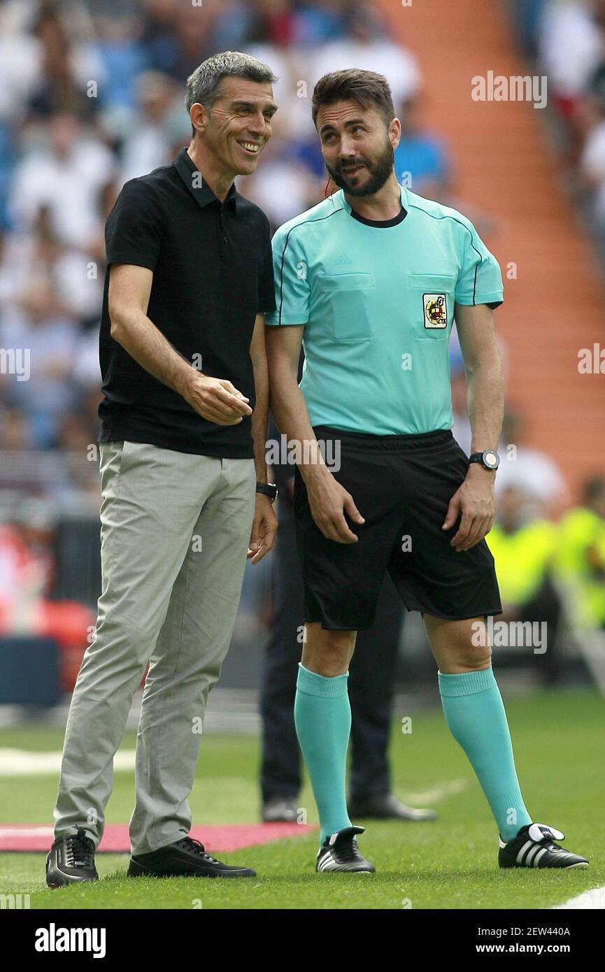Levante UD's coach Juan Ramon Lopez Muniz jokes with the fourth referee ...
