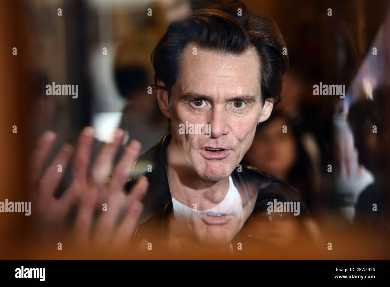 Seen through a bevelled glass, actor and comedian Jim Carrey attends ...