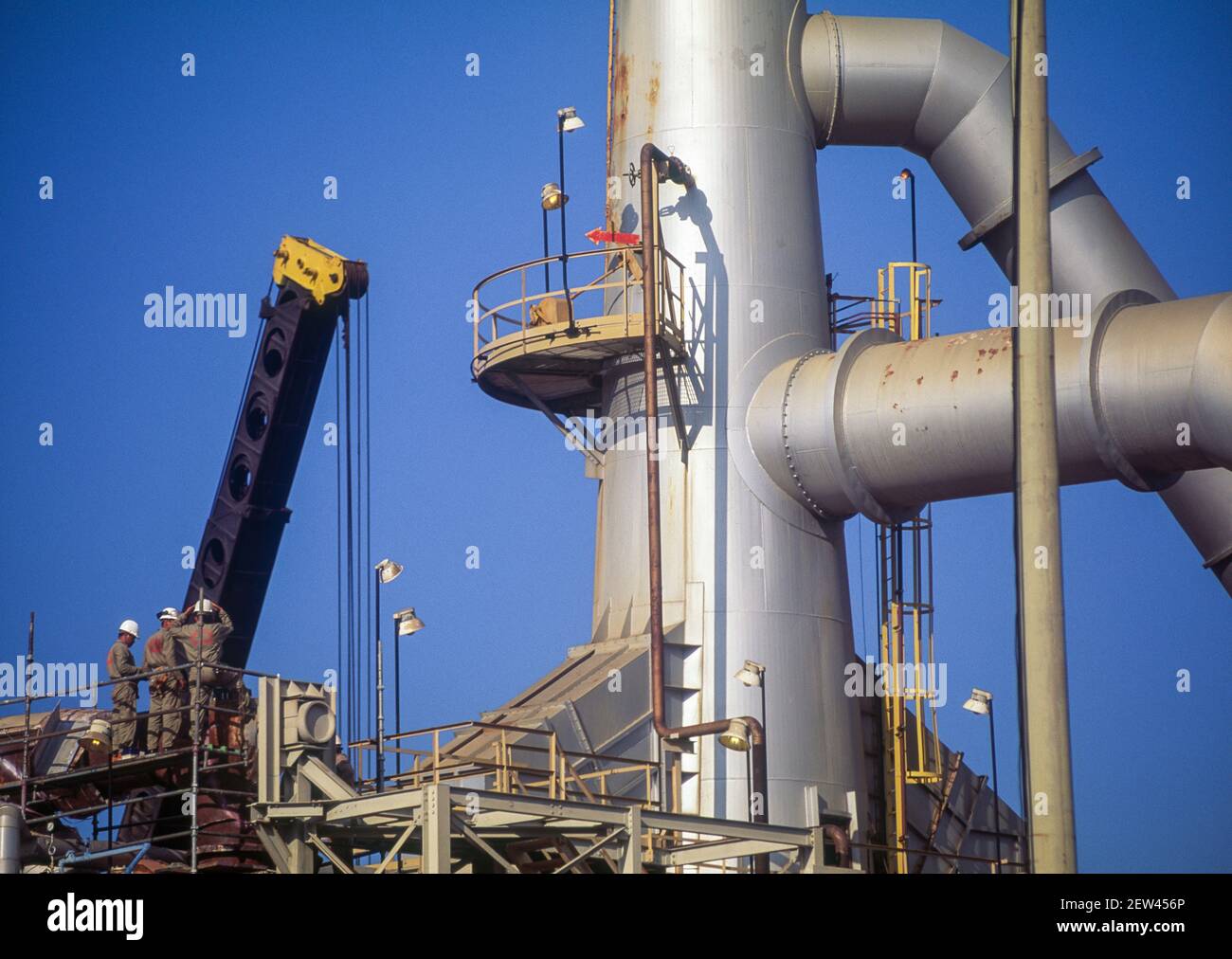 Workers on scaffold doing maintenance in oil refinery, Venezuela ...