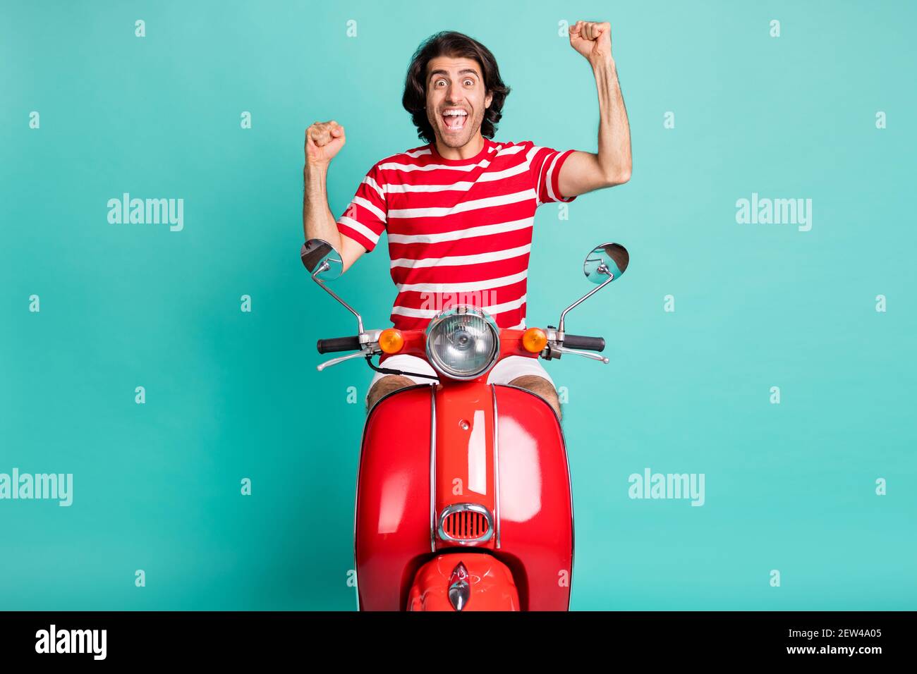 Portrait of nice cheerful lucky guy riding moped having fun rejoicing ...
