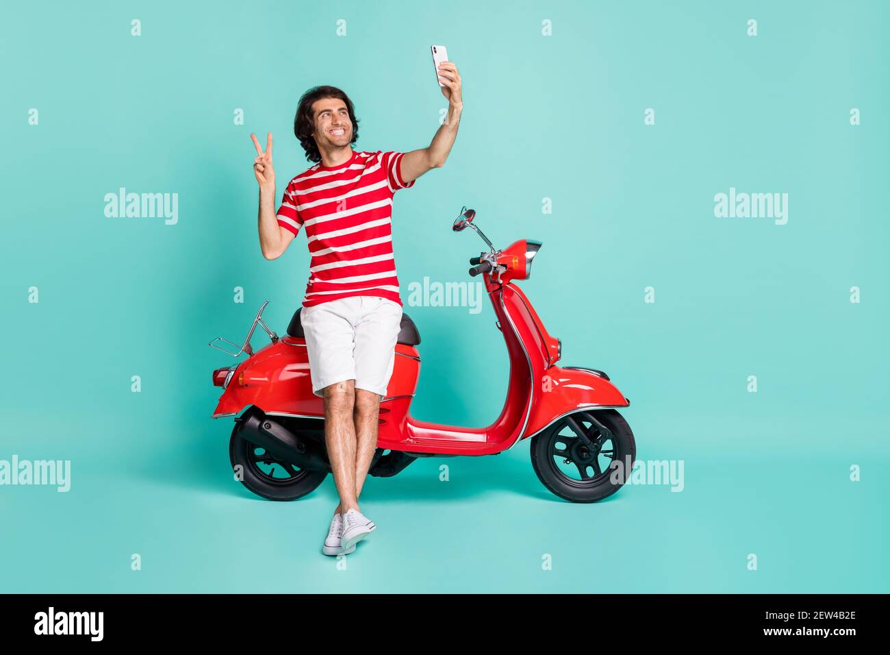 Full length body size view of nice cheerful guy sitting moped taking ...