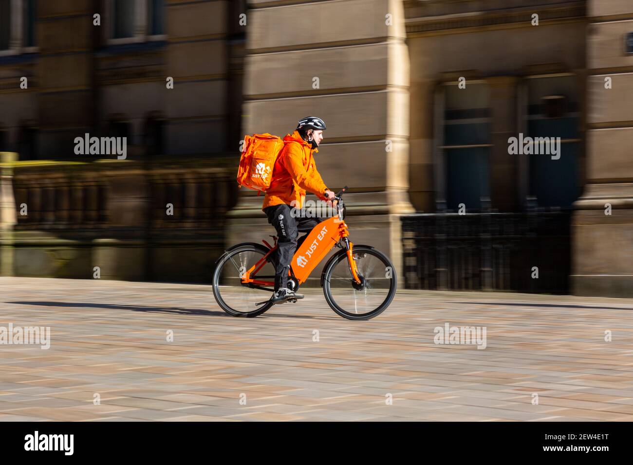 Fast food delivery cyclist in a city centre, UK Stock Photo - Alamy