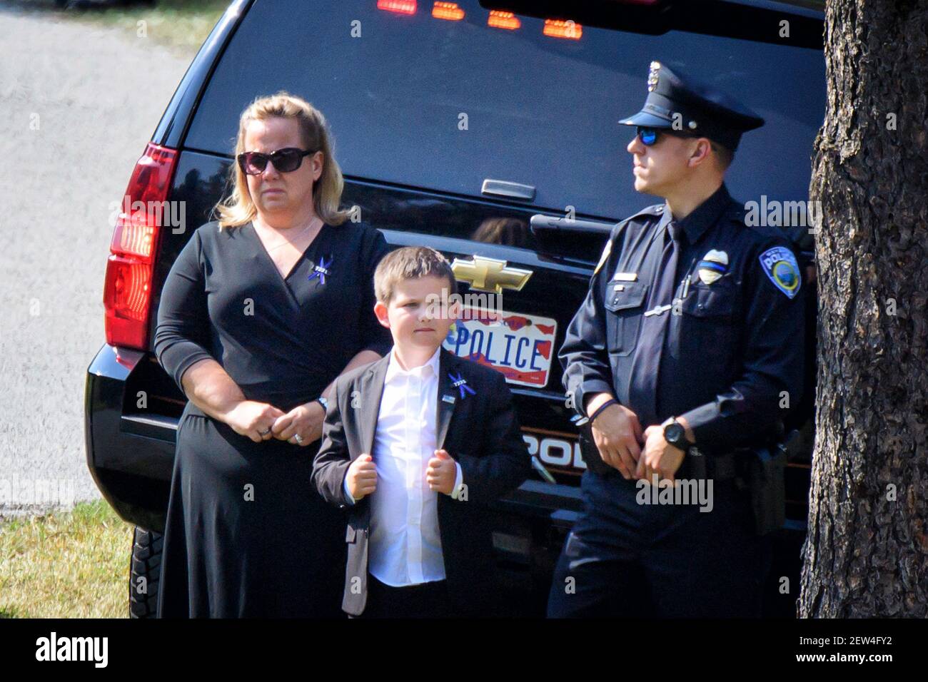 Shawn Mathews and her son Wyatt wait for her husband's casket to arrive ...