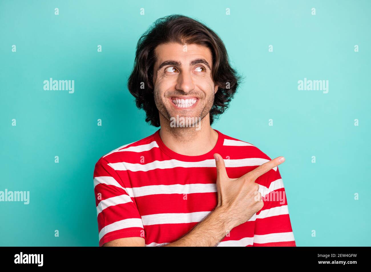Portrait of attractive cheerful guy demonstrating copy space empty ...