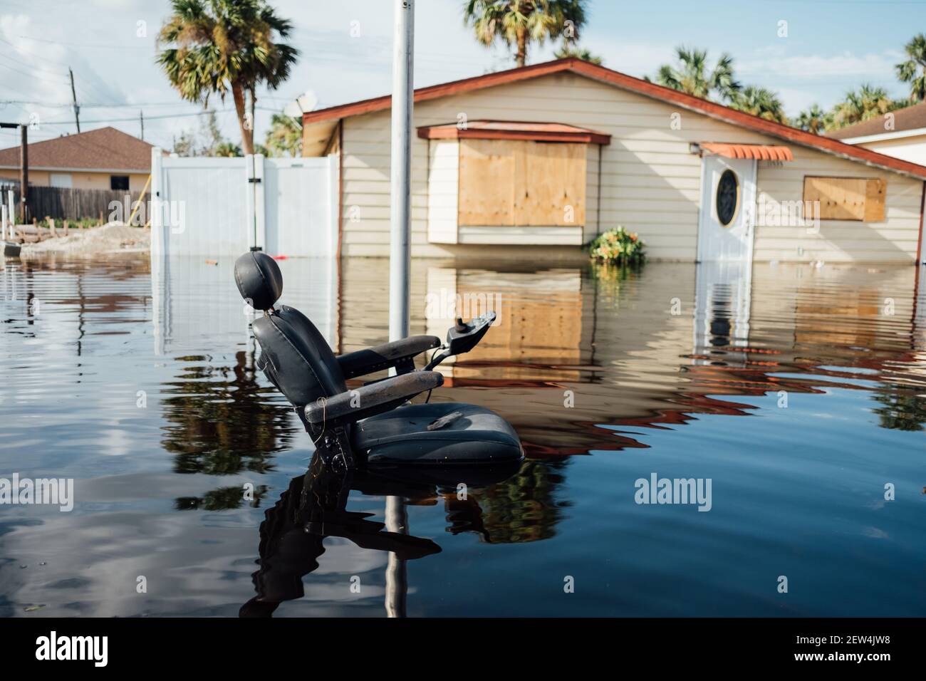 An electric wheelchair sits in flood waters after being left behind ...
