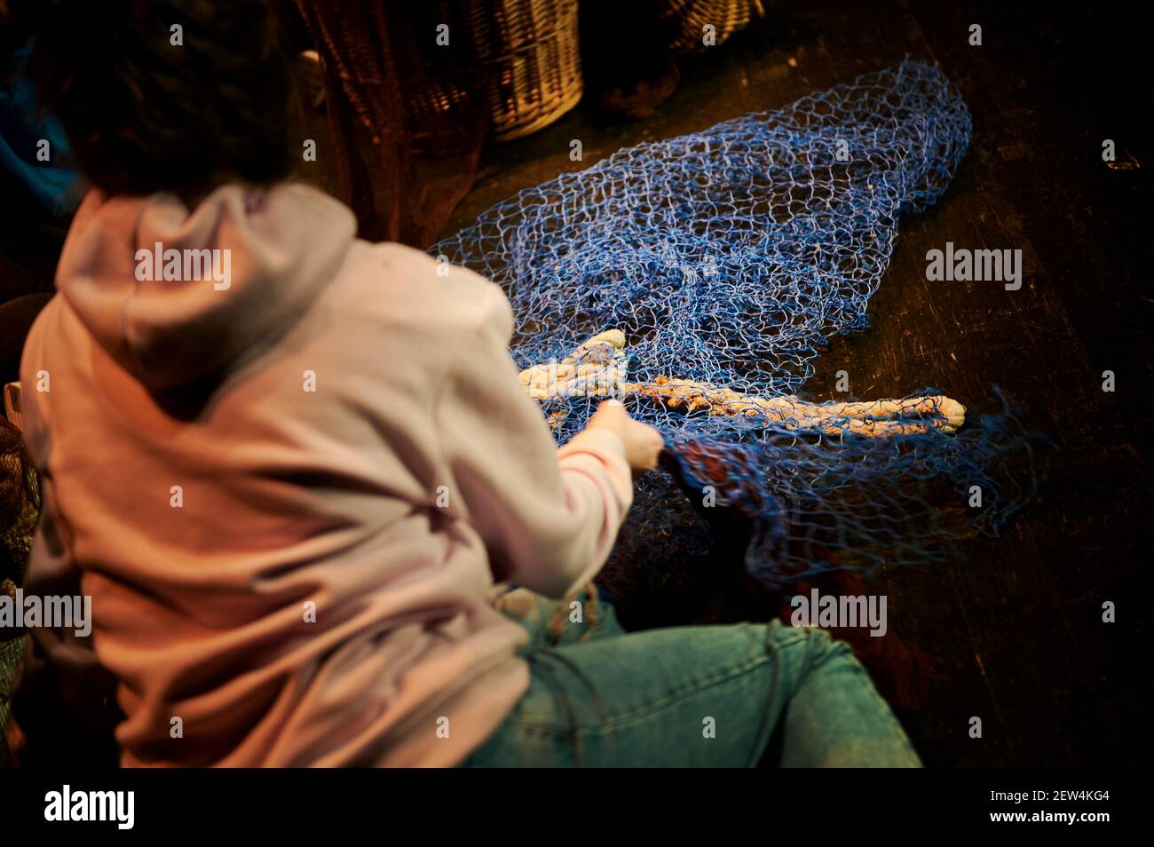 Woman netting fish hi-res stock photography and images - Alamy