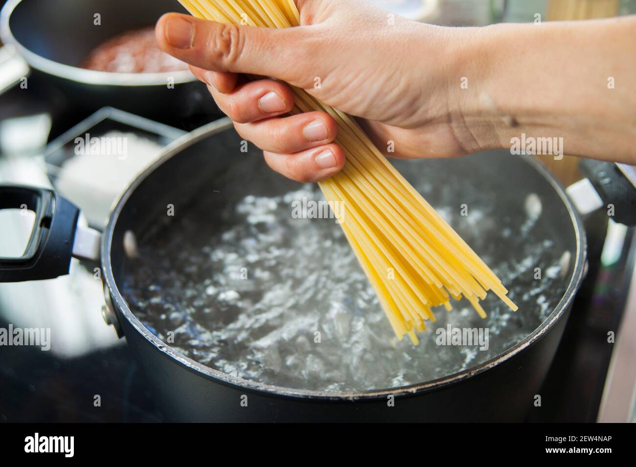 Cooking spaghetti in a pot with boiling water Stock Photo - Alamy