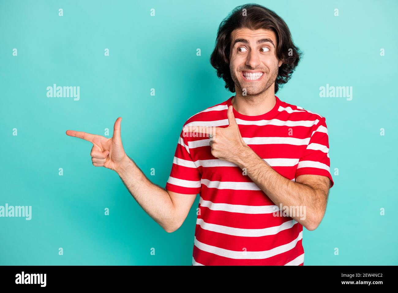 Portrait of handsome cheerful curious guy demonstrating copy space look ...