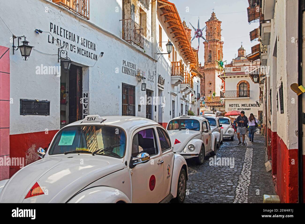 White Volkswagen Beetle taxis in narrow street in the colonial city ...
