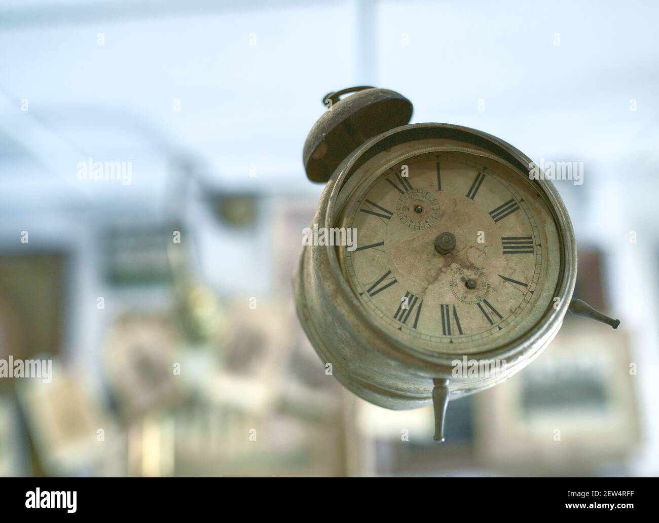 Very old gold alarm clock with bell floating in the air with light ...