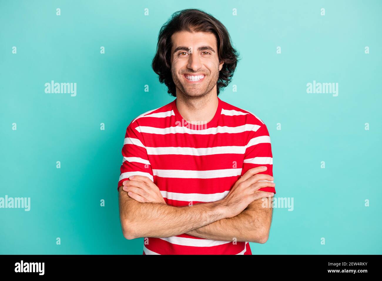 Portrait of attractive cheerful glad content brown-haired guy folded ...