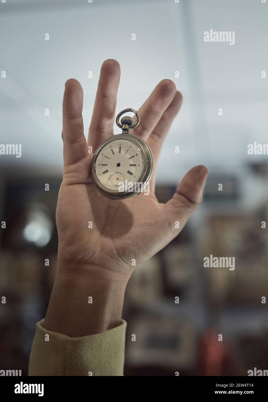 Hand catching a gold old pocket watch that floats in the air Stock ...