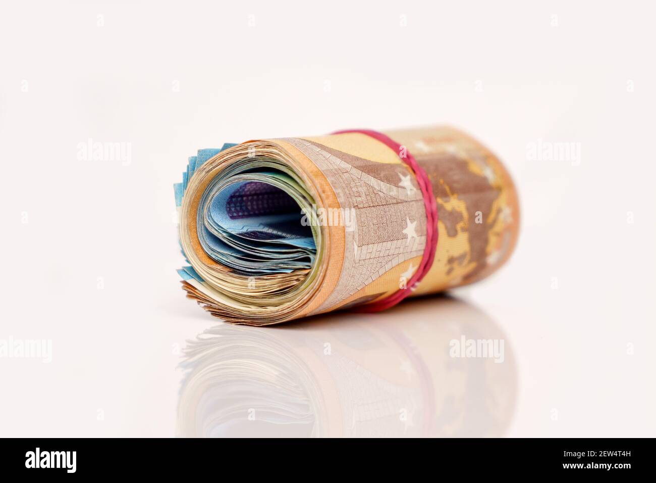 Roll of many euro money and bow isolated on white background Stock ...