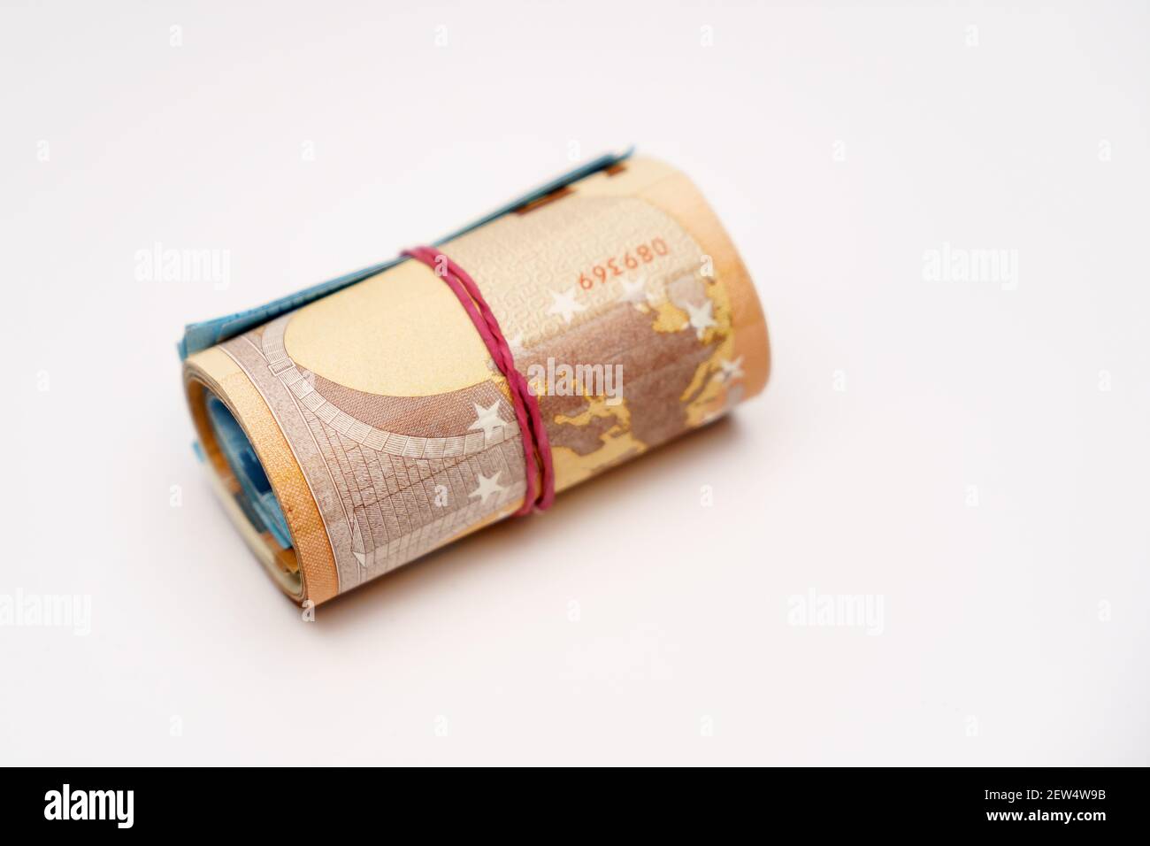 Roll of many euro money and bow isolated on white background Stock ...