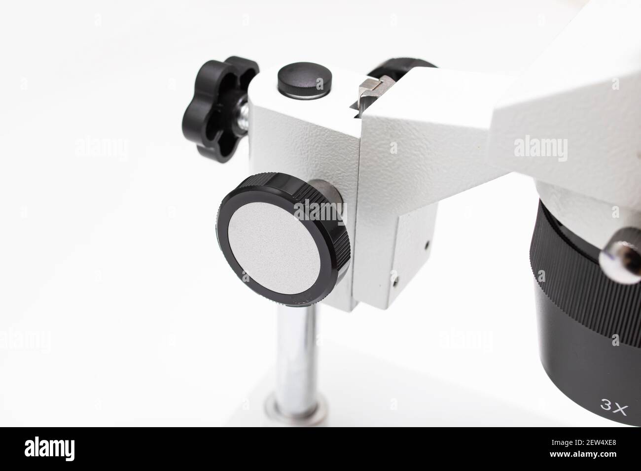 Large metal microscope on a white background Stock Photo - Alamy