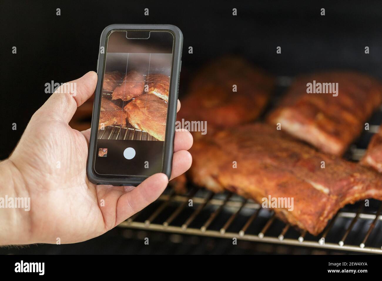 Taking photo of the Beef Ribs being cooked on Barbecue Grill. Backyard ...