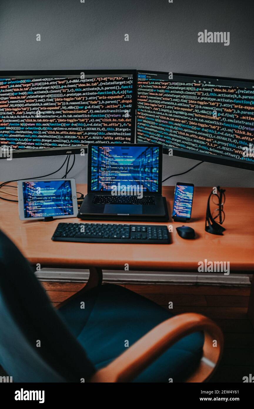 A vertical shot of programmer's desk with types of electronic equipment ...