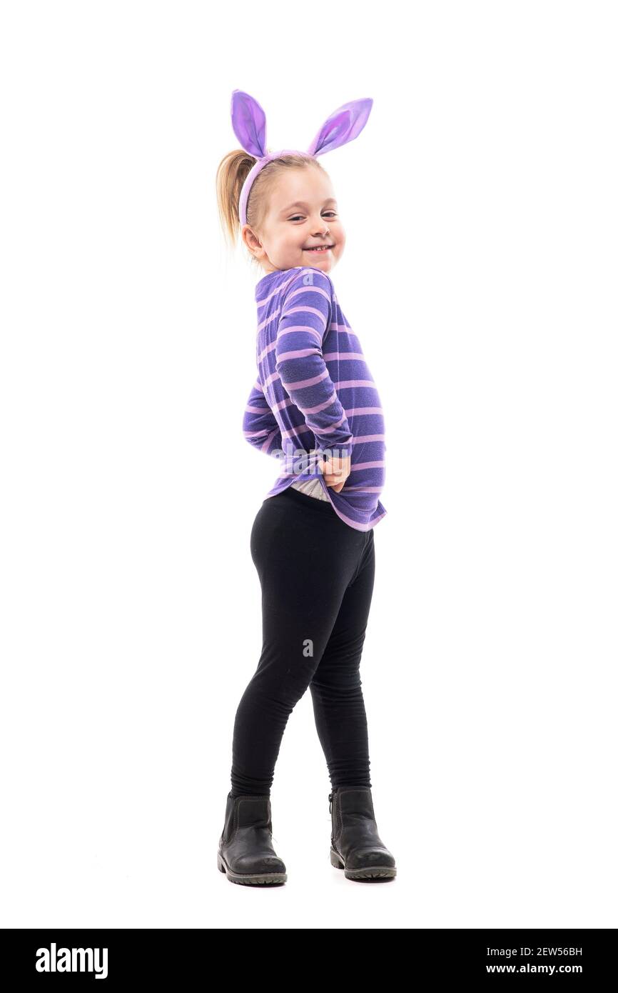 Happy cute little girl with Easter bunny ears hat posing akimbo pose ...