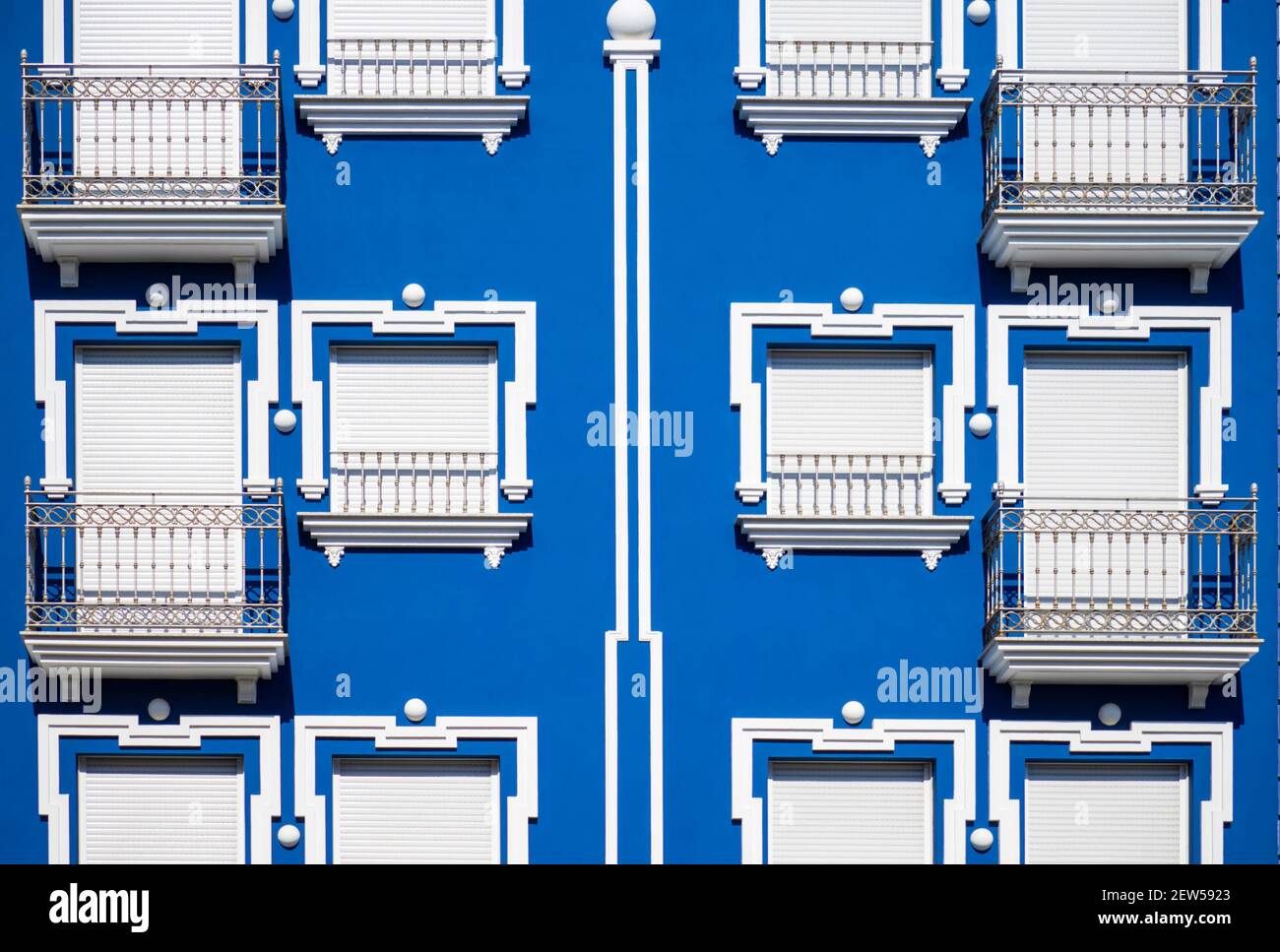 Blue facade of residential buildinth white windows Stock Photo - Alamy